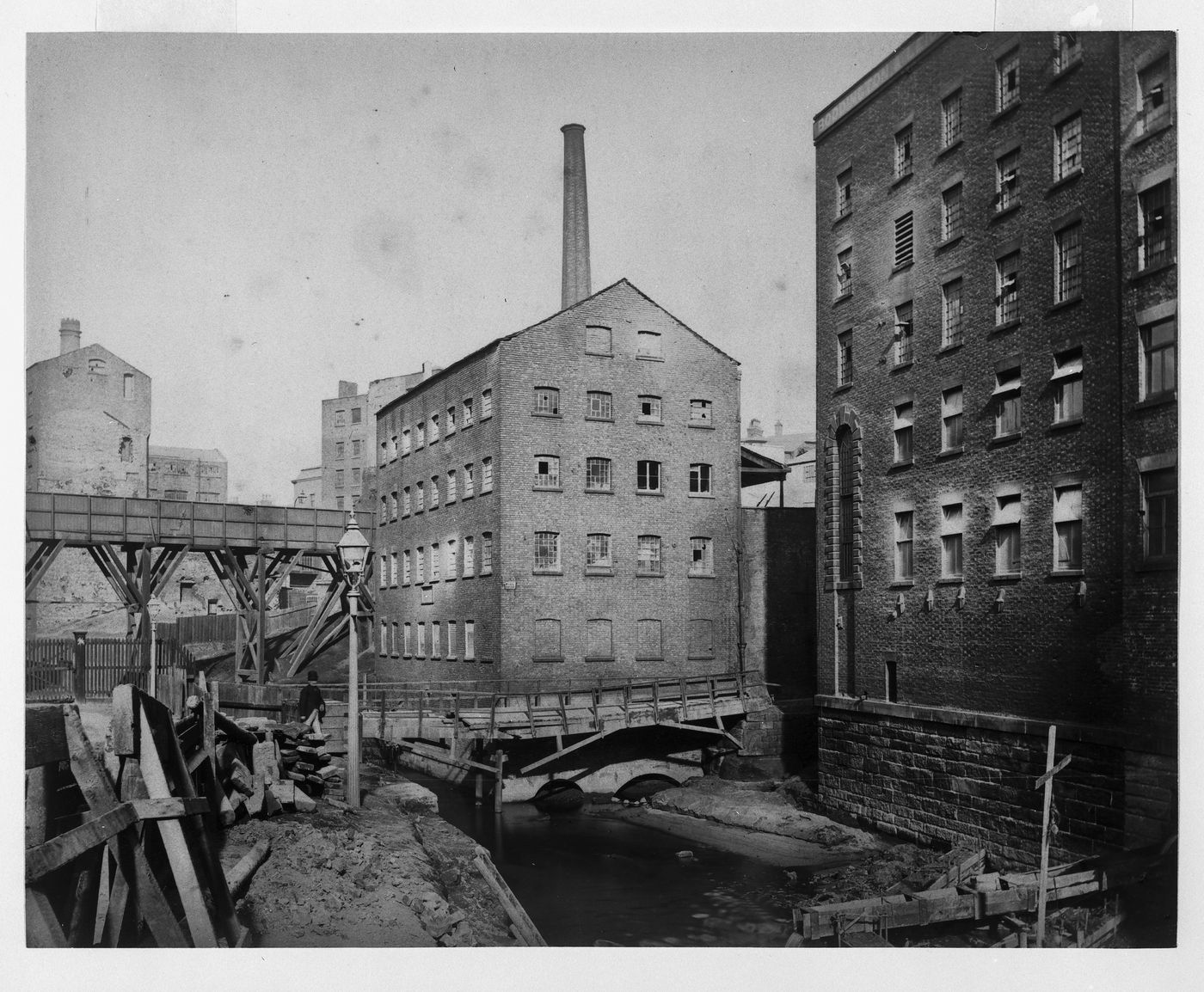 View of footbridge over the river Irk and School Mills, Manchester, England
