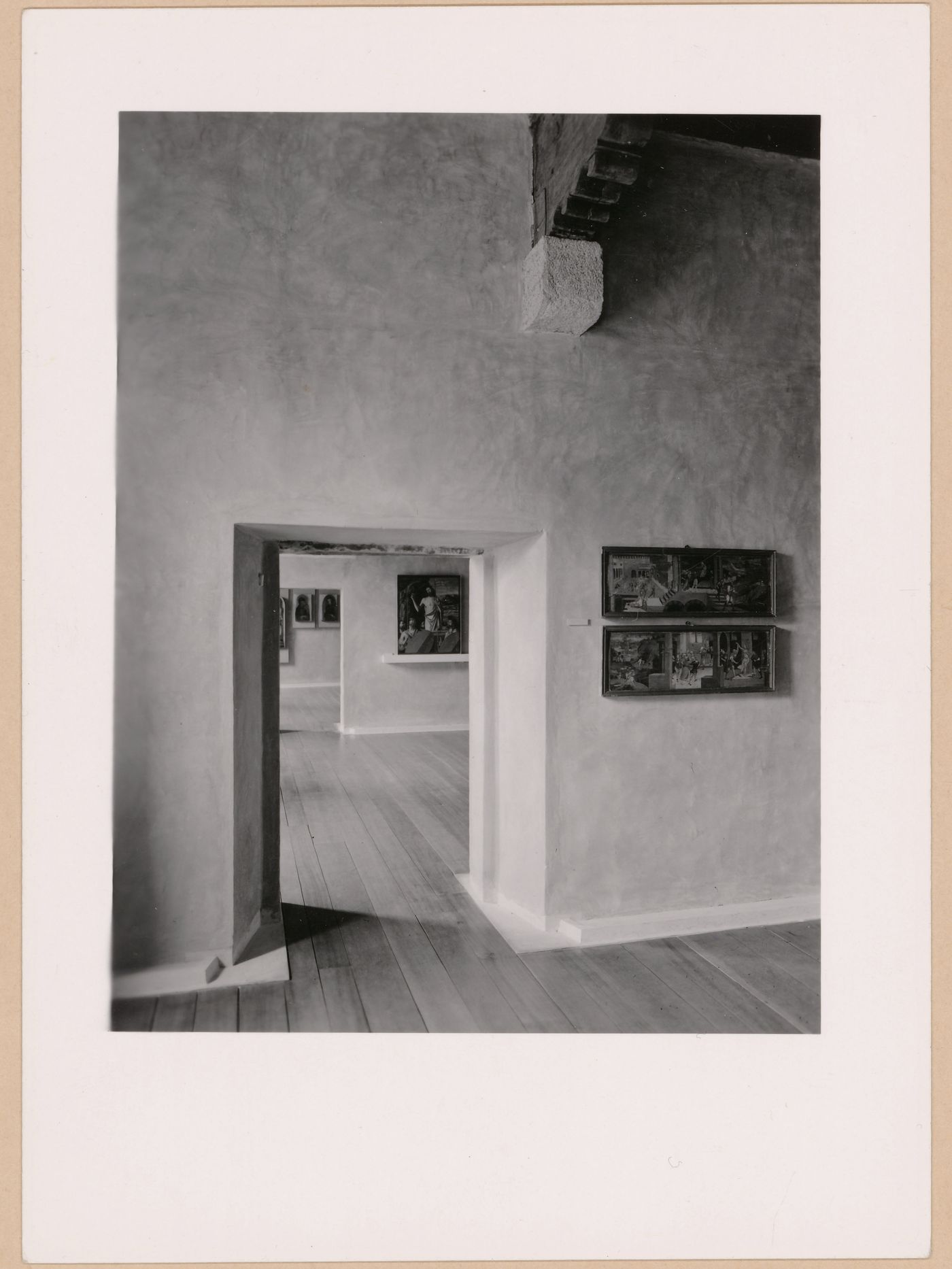 Interior view of a gallery showing doorways, paintings and other ...