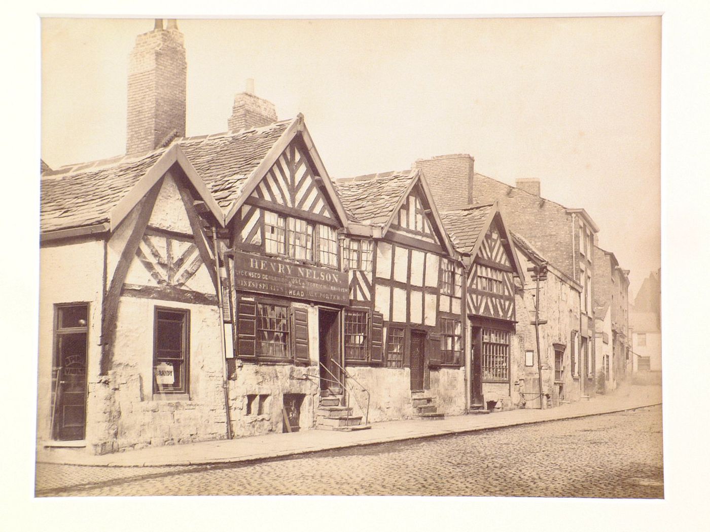 View of a street of small shops and houses, Manchester, England