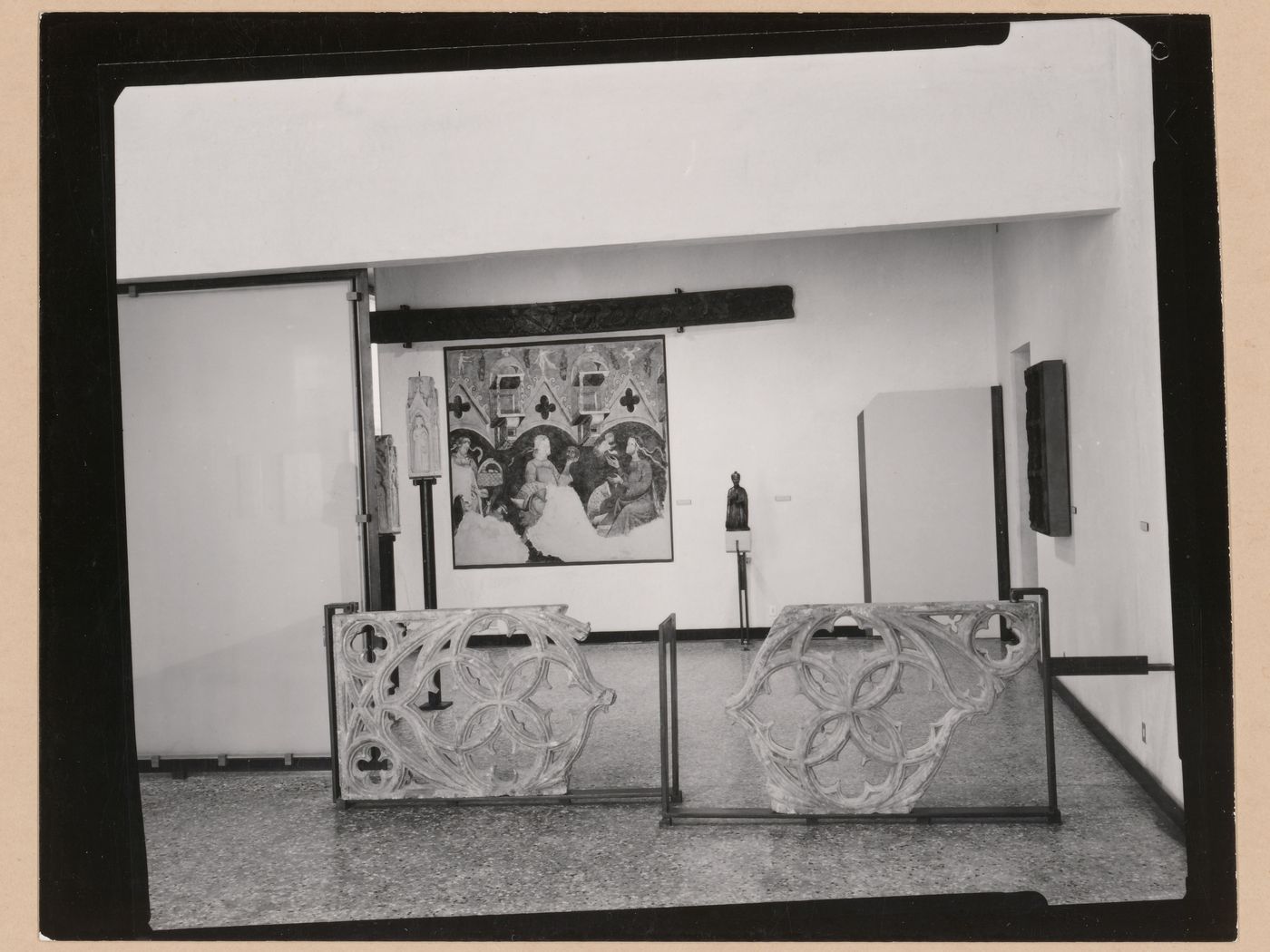 Interior view of a gallery showing fragments of stone tracery, a ...